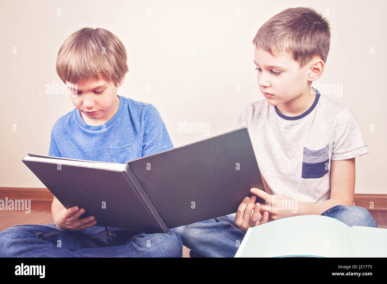 Kids reading books at home Stock Photo - Alamy