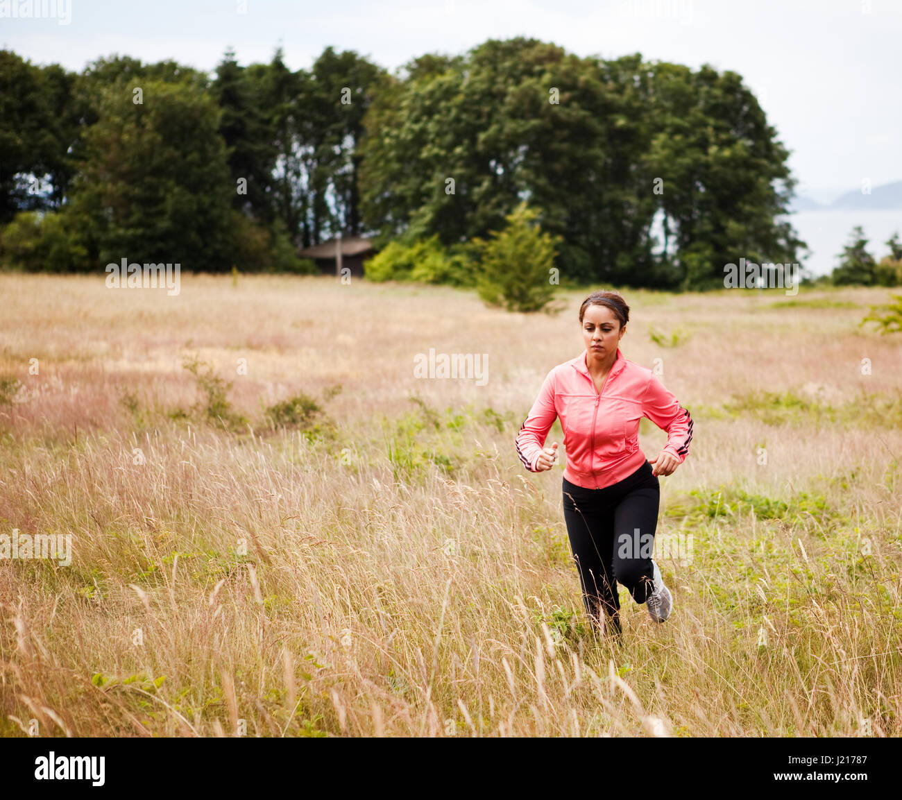 A beautiful asian woman running in a park Stock Photo - Alamy