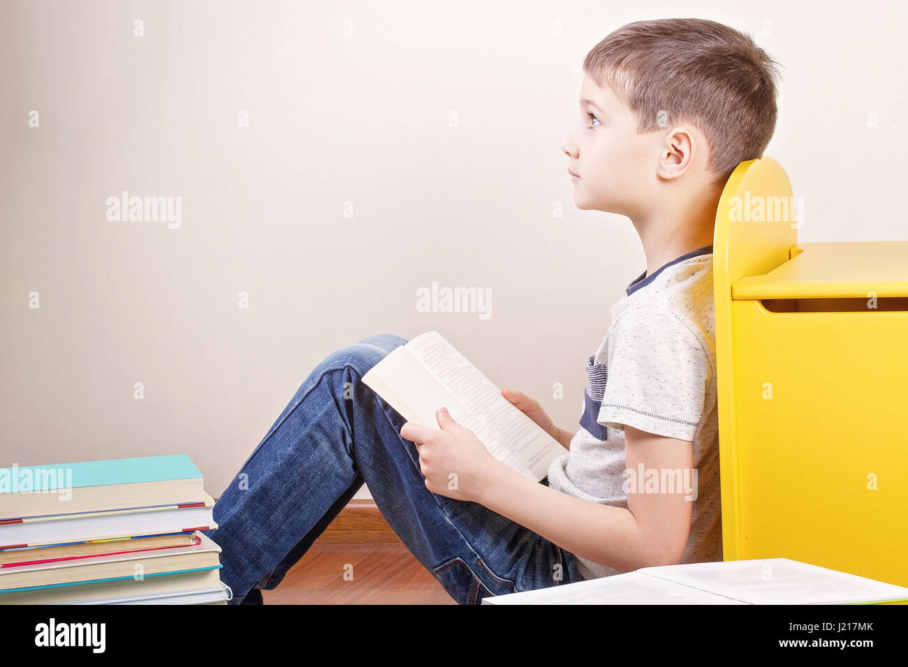 Boy reading books at home Stock Photo - Alamy