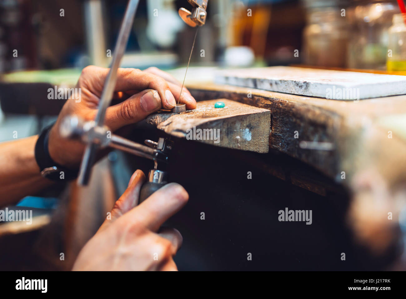 Goldsmith working and creating jewelry Stock Photo - Alamy