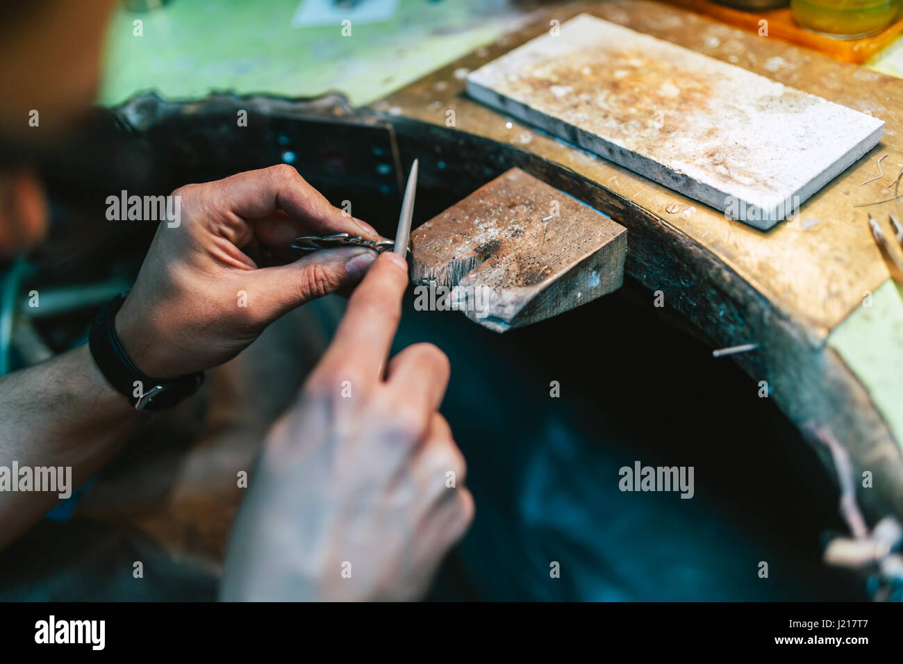 Goldsmith working and creating jewelry Stock Photo - Alamy