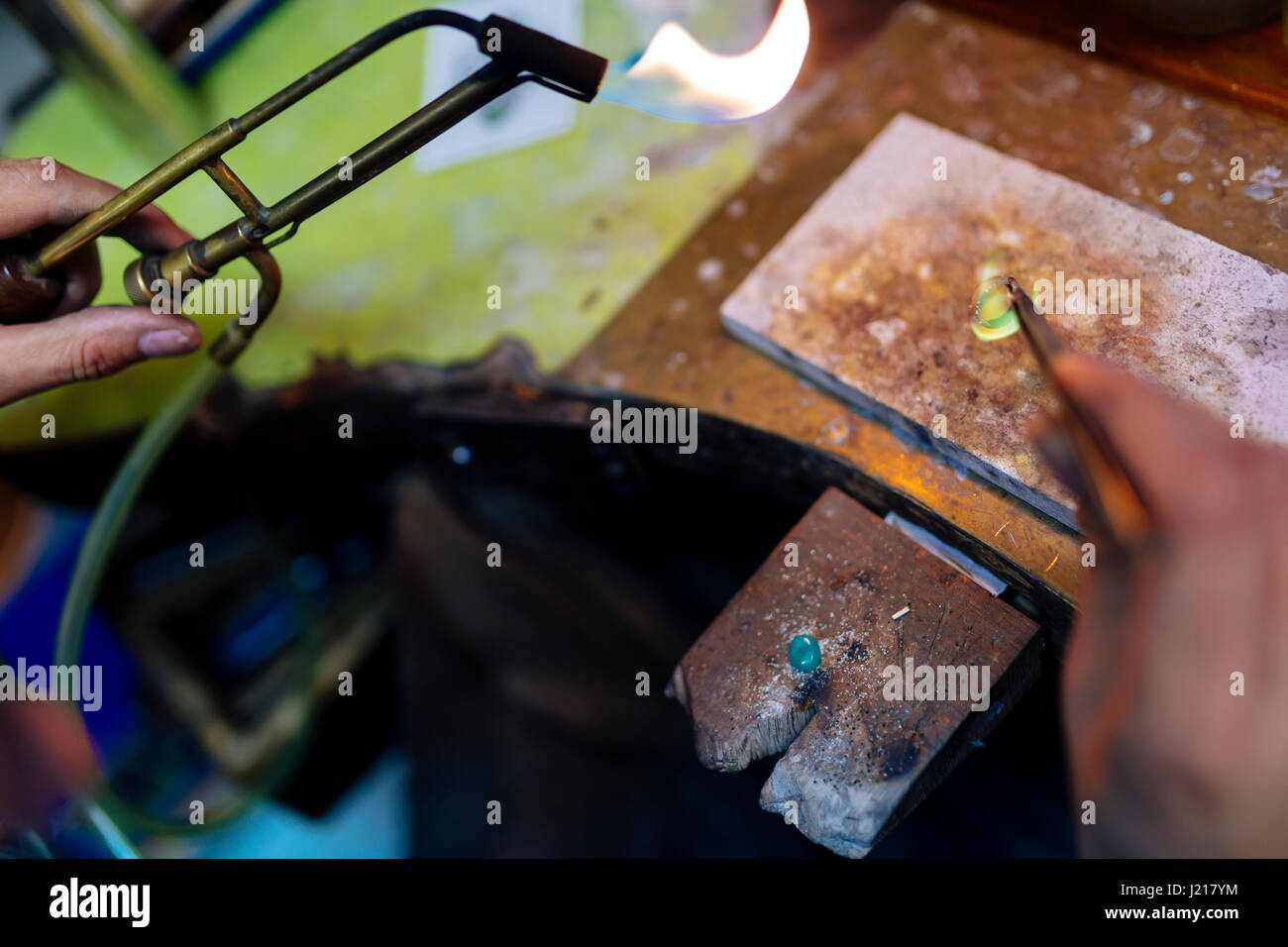 Goldsmith working on a ring with torch Stock Photo - Alamy