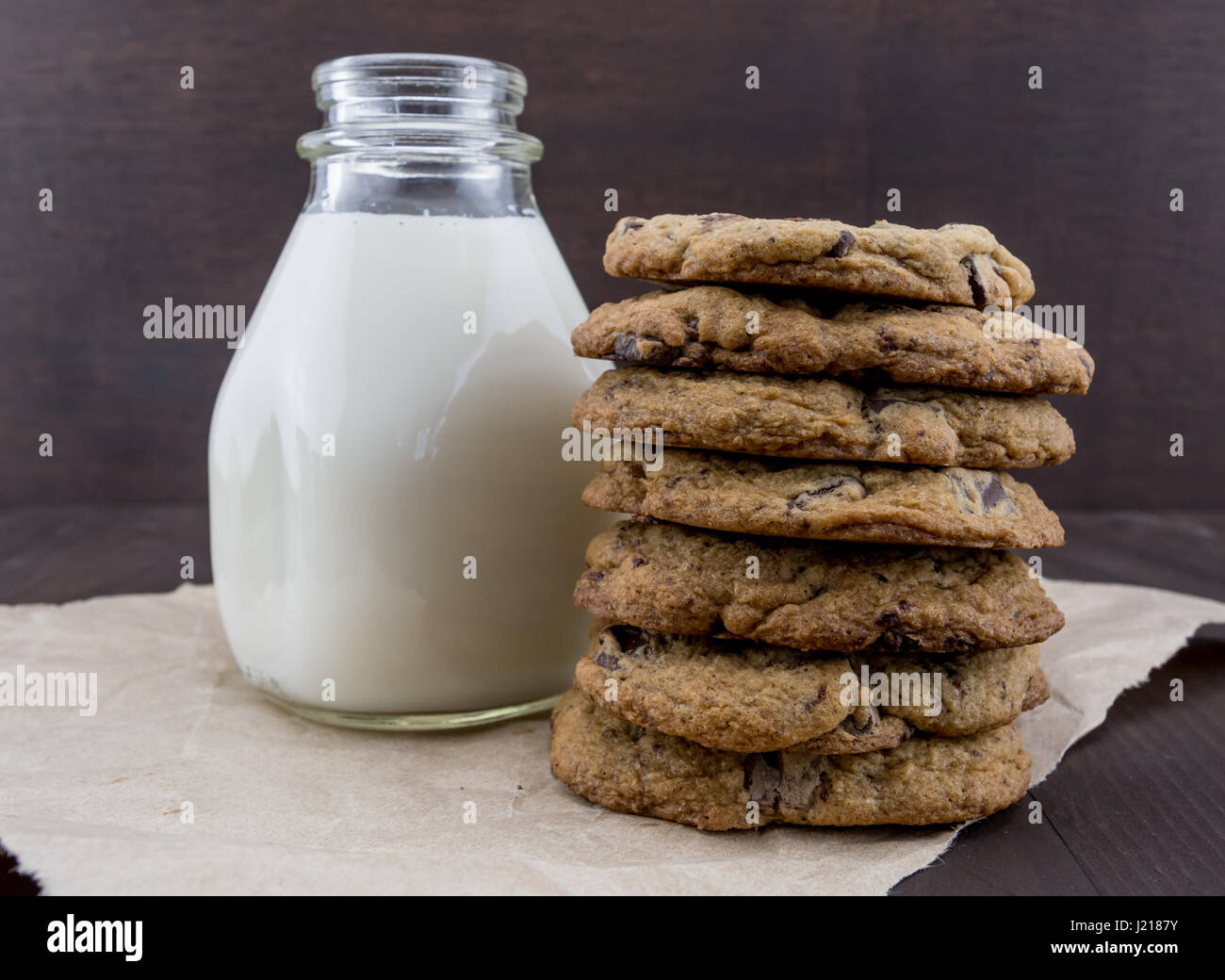 Tall Stack of Chocolate Cookies with Milk in Vintage Jar Stock Photo ...