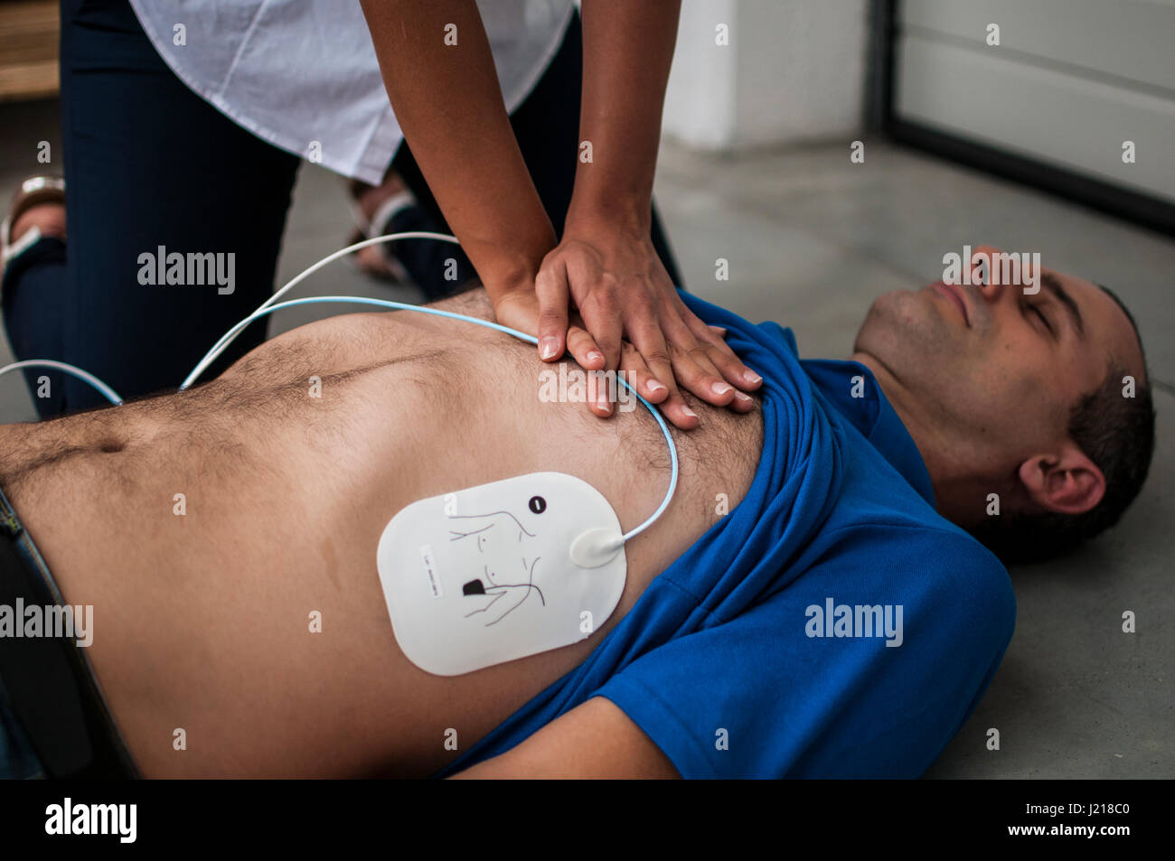 a girl helping a guy after heart attack with cardiopulmonary ...