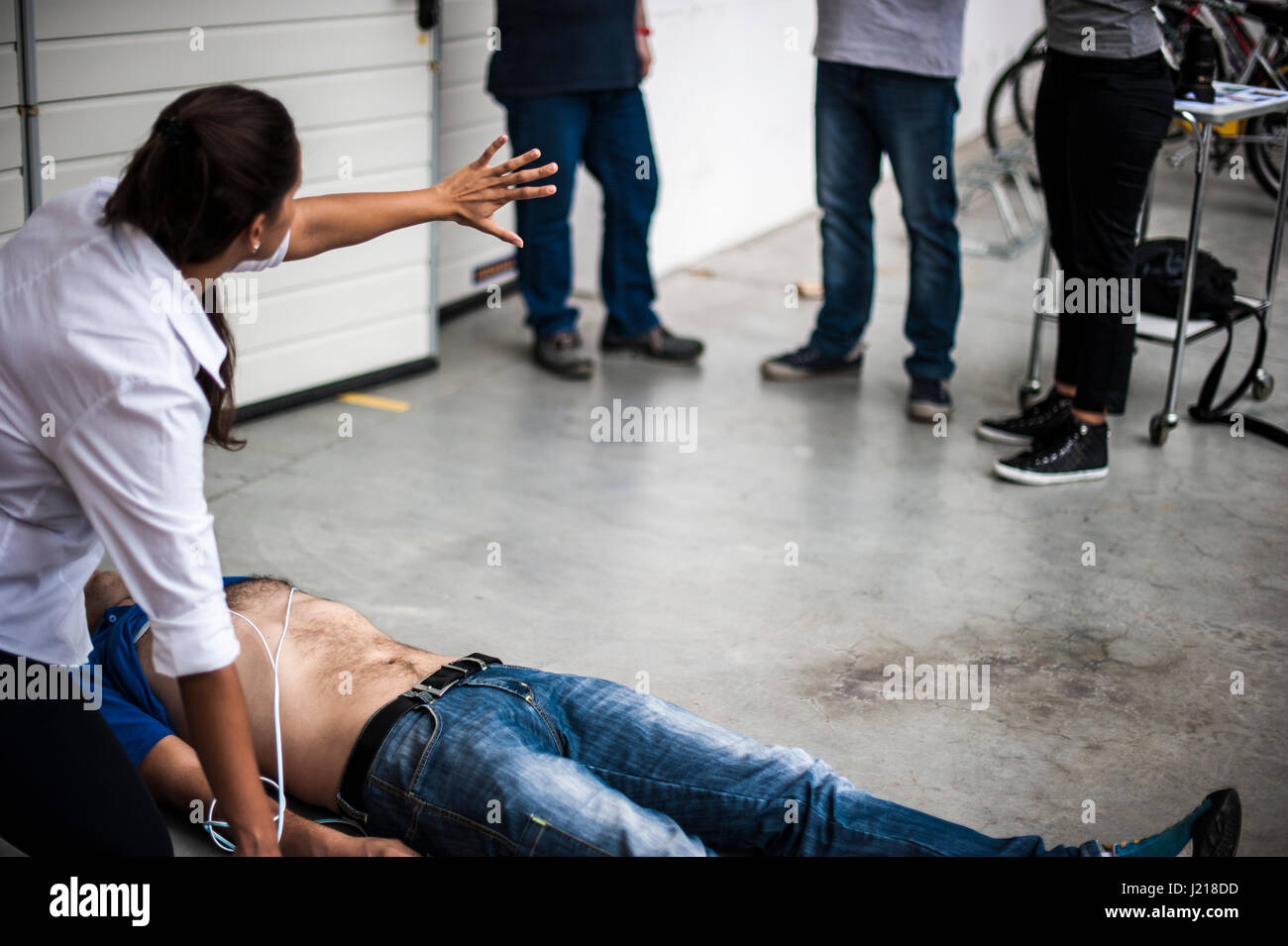 a girl helping a guy after heart attack with cardiopulmonary ...