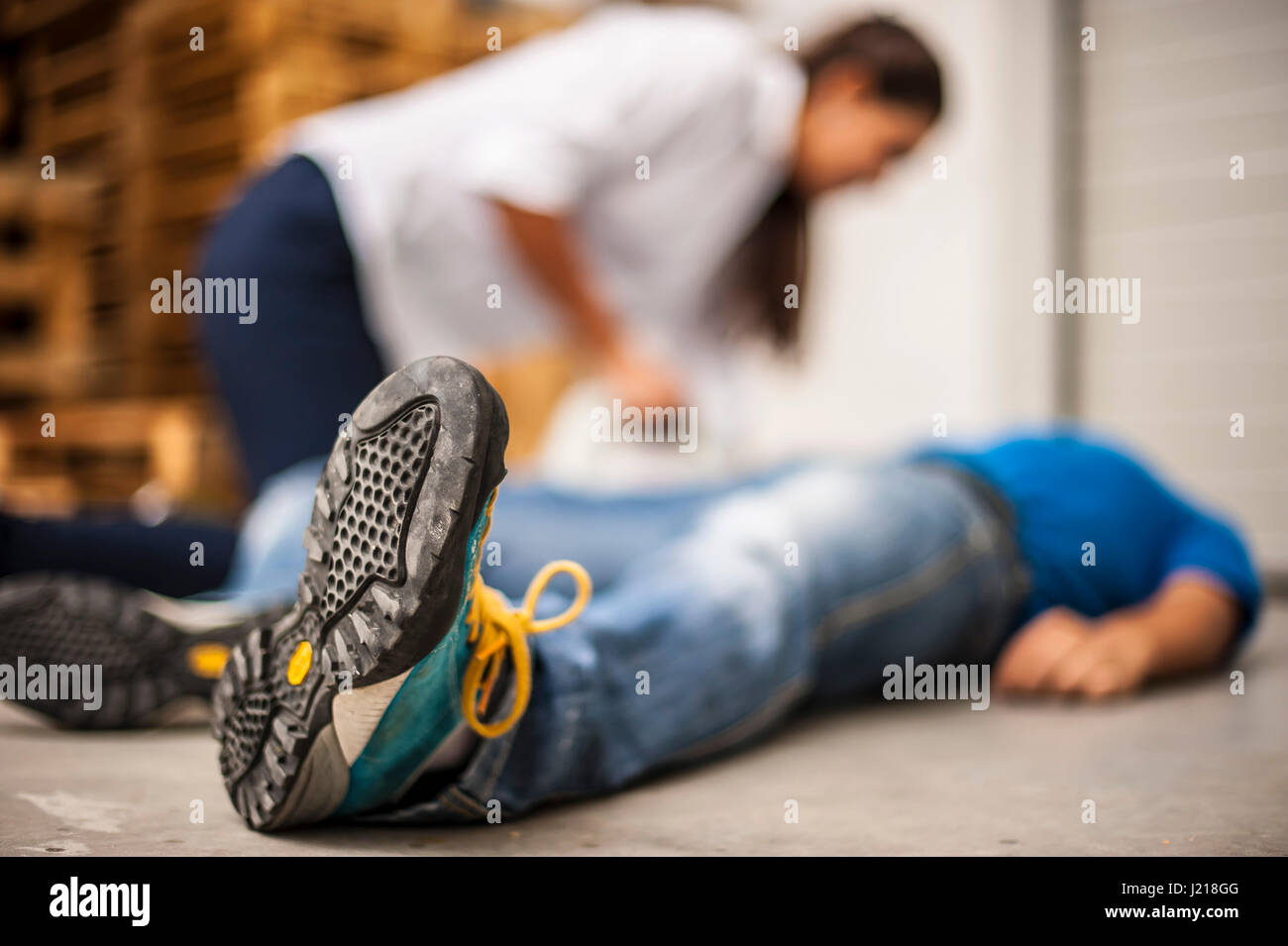 a girl helping a guy after heart attack with cardiopulmonary ...