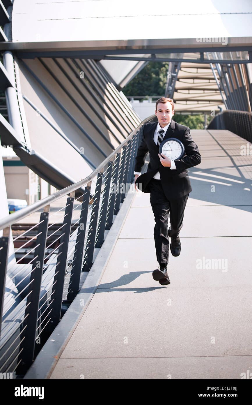 A late caucasian businessman running in a rush Stock Photo - Alamy