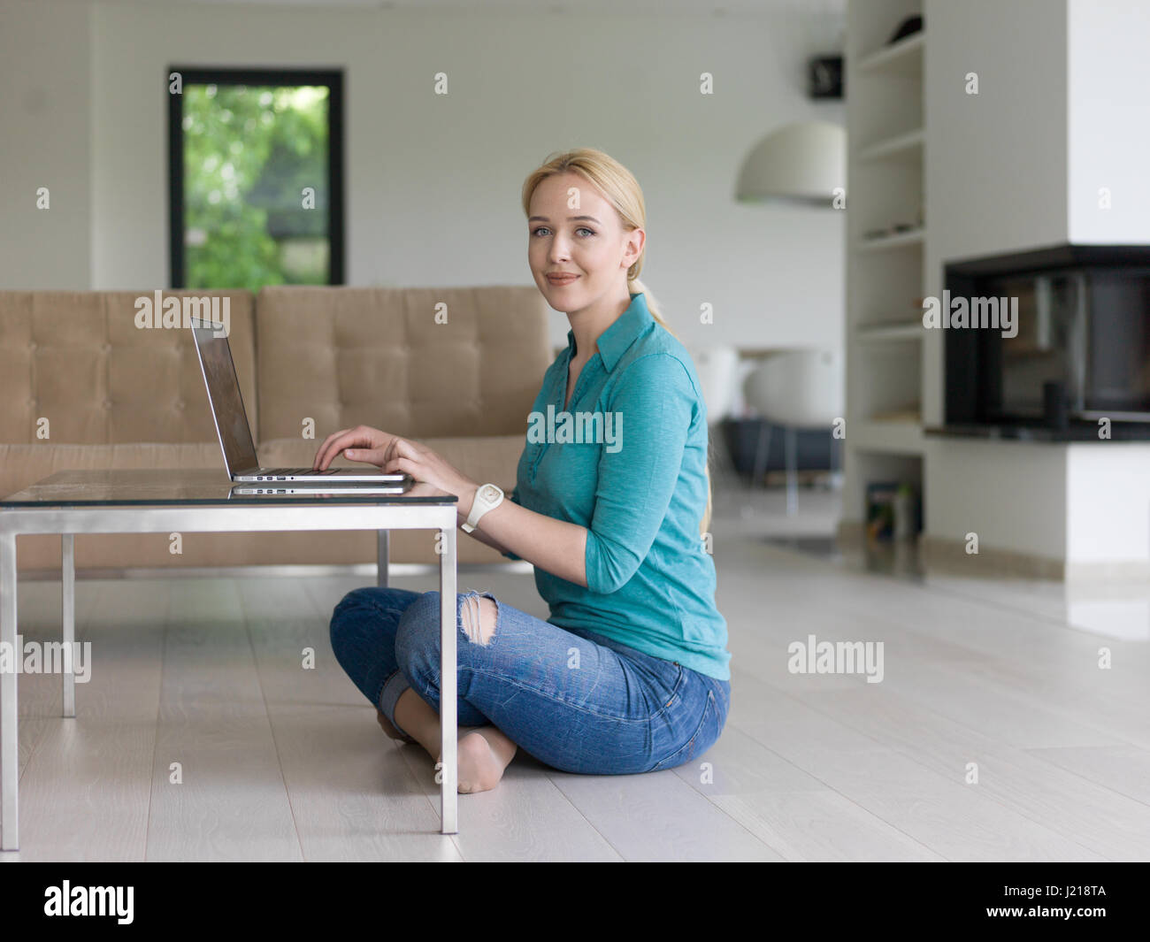 beautiful young women using laptop computer on the floor of her luxury ...