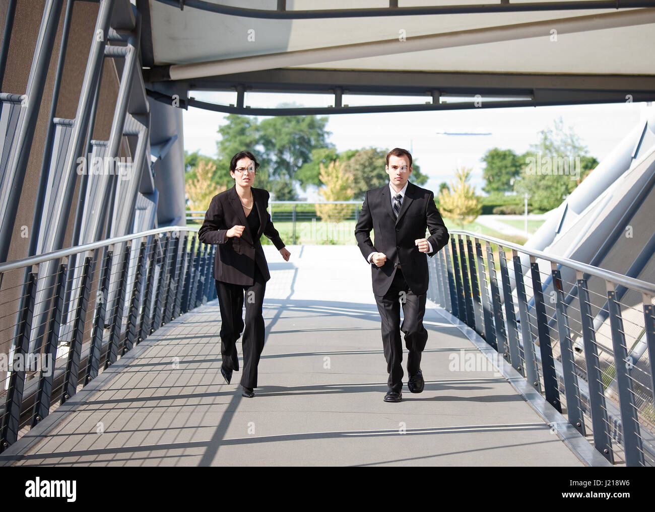 A shot of two business people running competing against each other ...