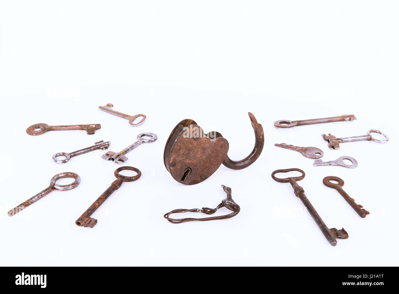 Ancient rusty padlock with collection of keys isolated on white ...