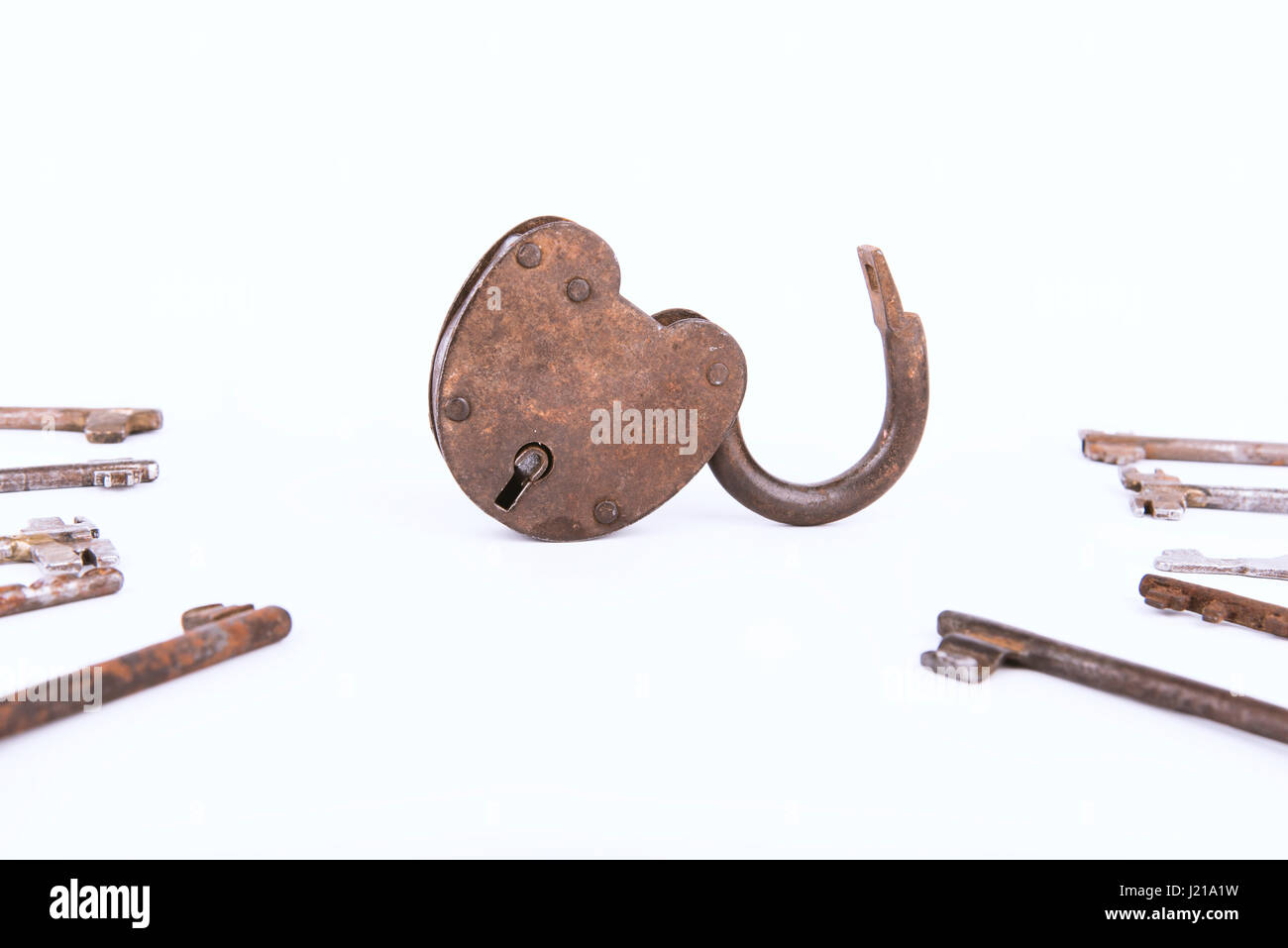 Ancient rusty padlock with collection of keys isolated on white ...