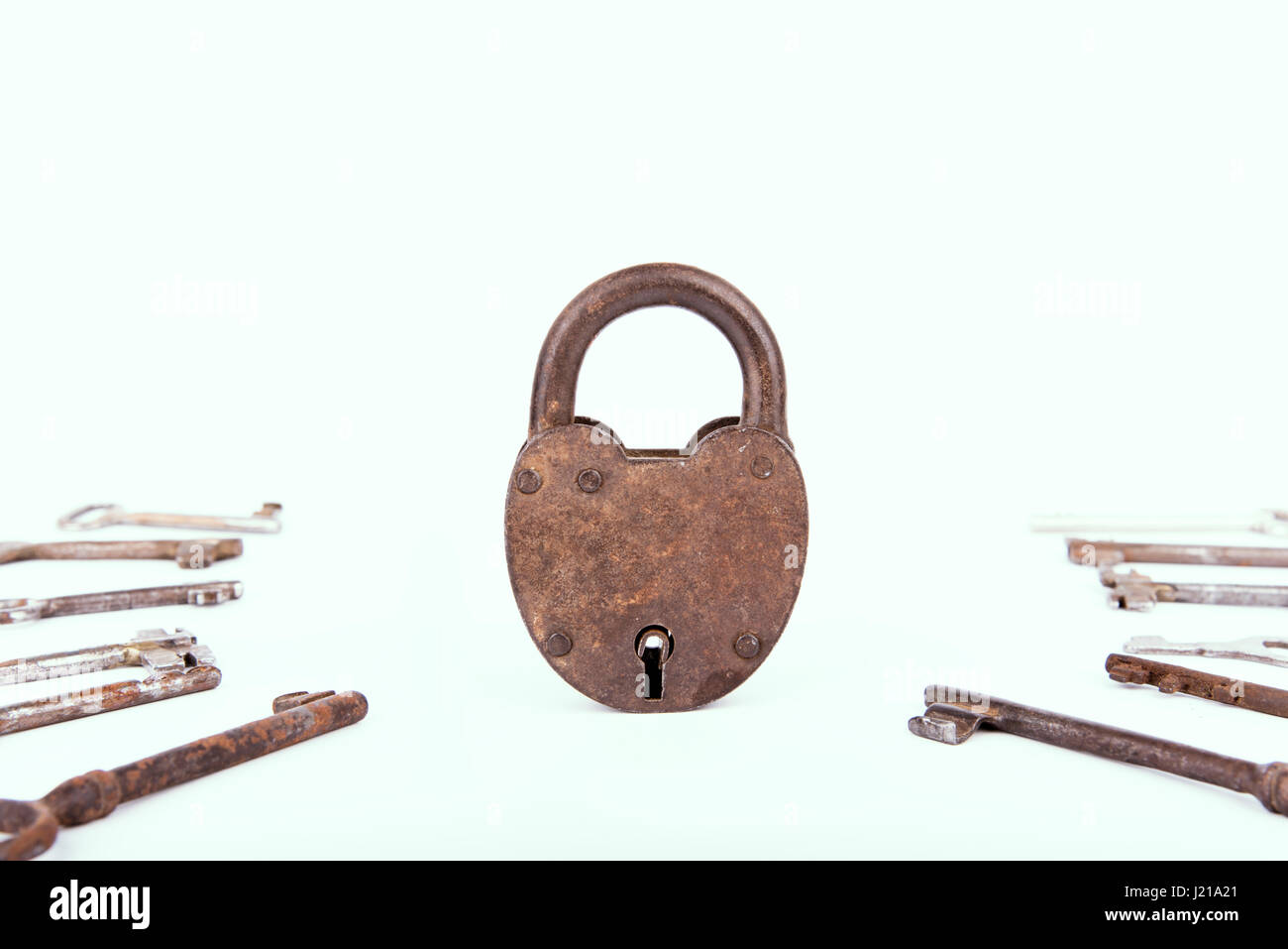 Ancient rusty padlock with collection of keys isolated on white ...