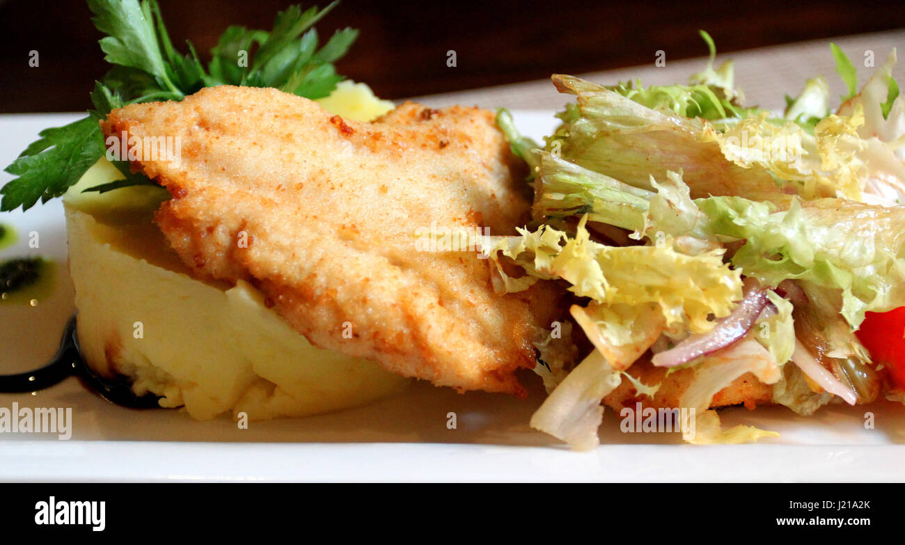 Photo of a delicious chicken schnitzel with salad in a cafe Stock Photo ...