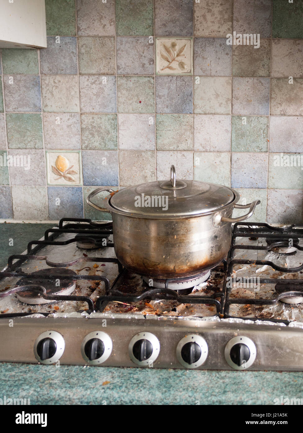 A Big Silver Metal Pan with Lid on And with A Burnt black and Brown ...