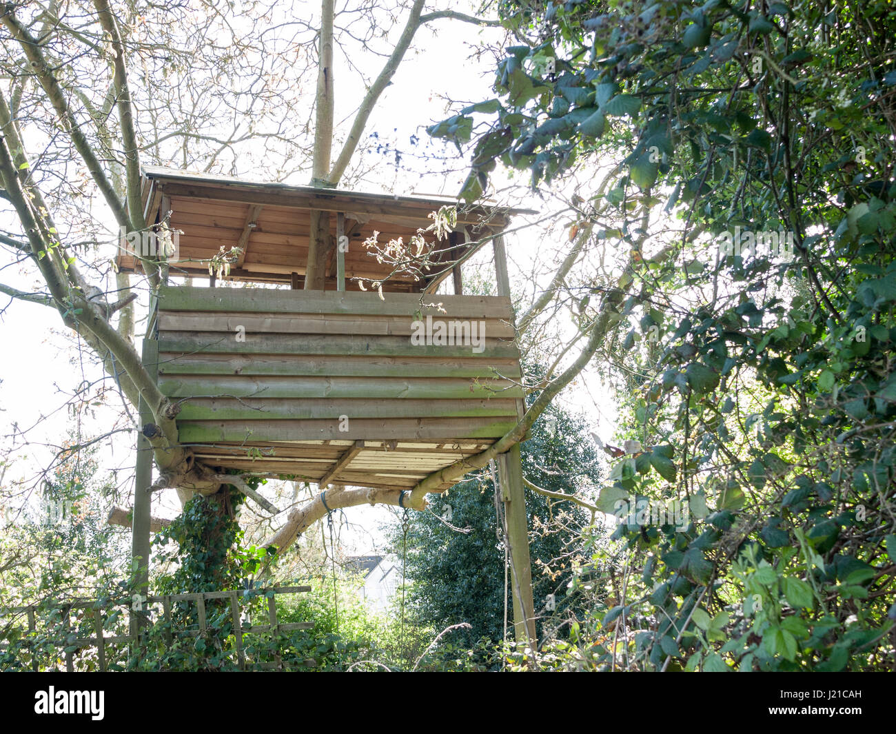 A Wooden Tree House in Someone's Back garden and Yard with A Roof and ...
