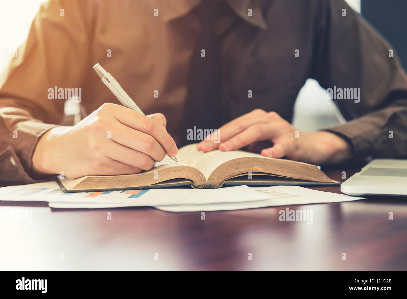 Close up hand business man writing book in the office with sunlight ...