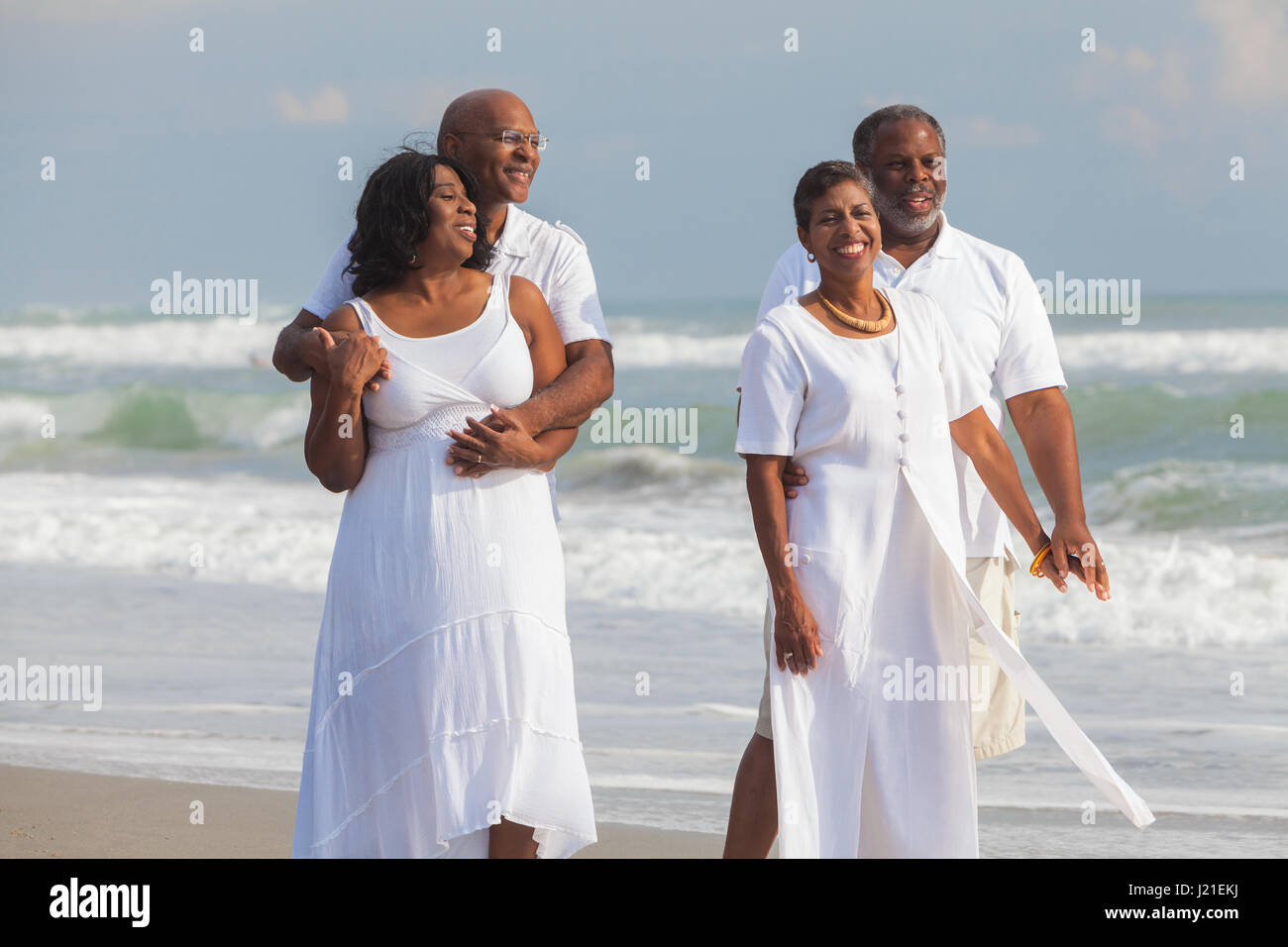 Happy romantic senior African American men and women couples walking on ...