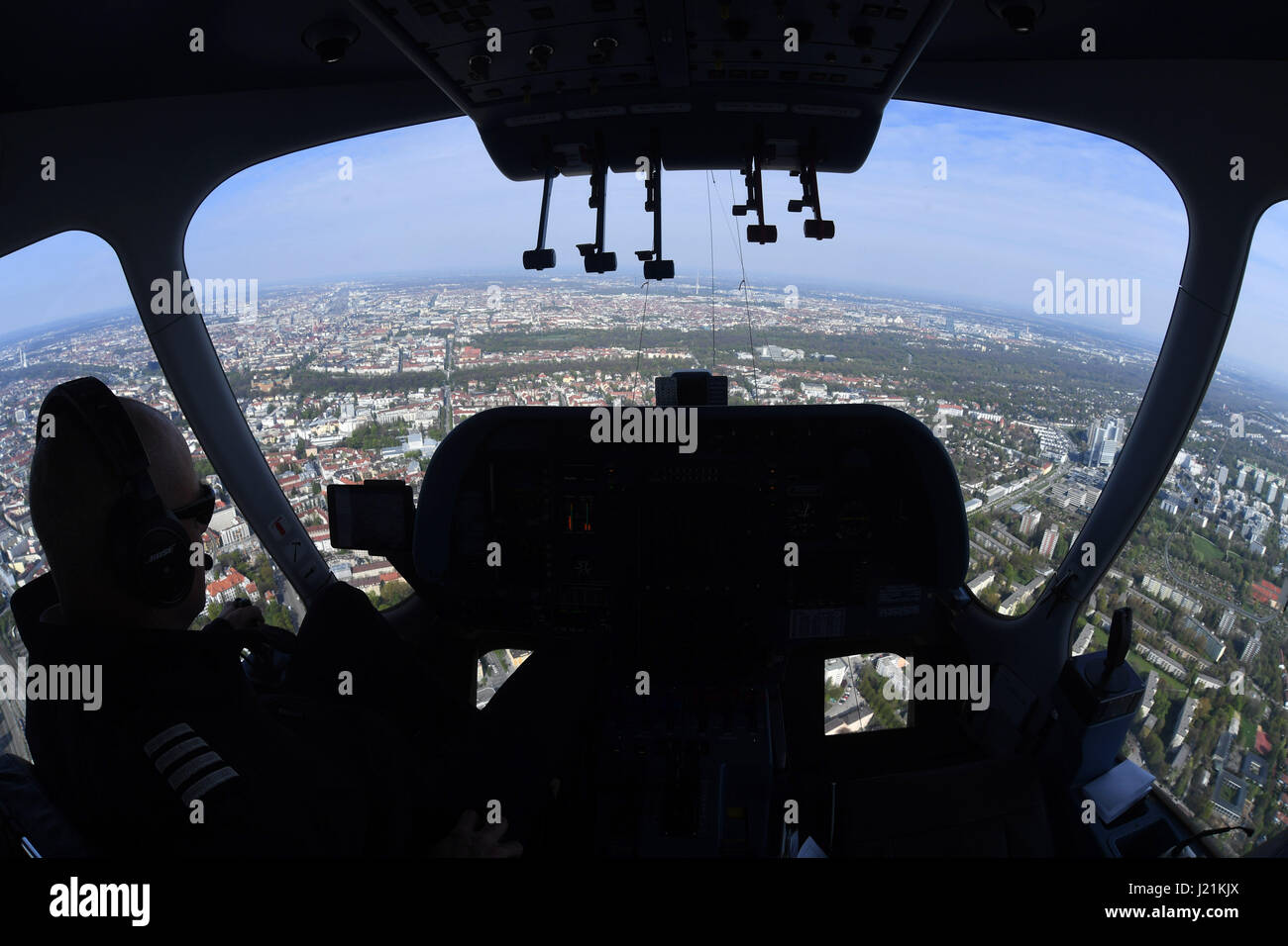 The cockpit of the zeppelin with the pilot flying over Munich, Germany ...