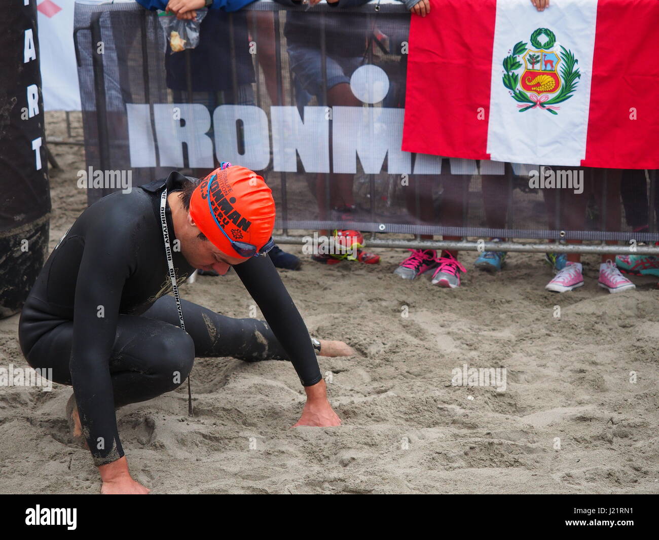 An athlete preparing to run in front of the Peruvian flag. Over 1653 ...