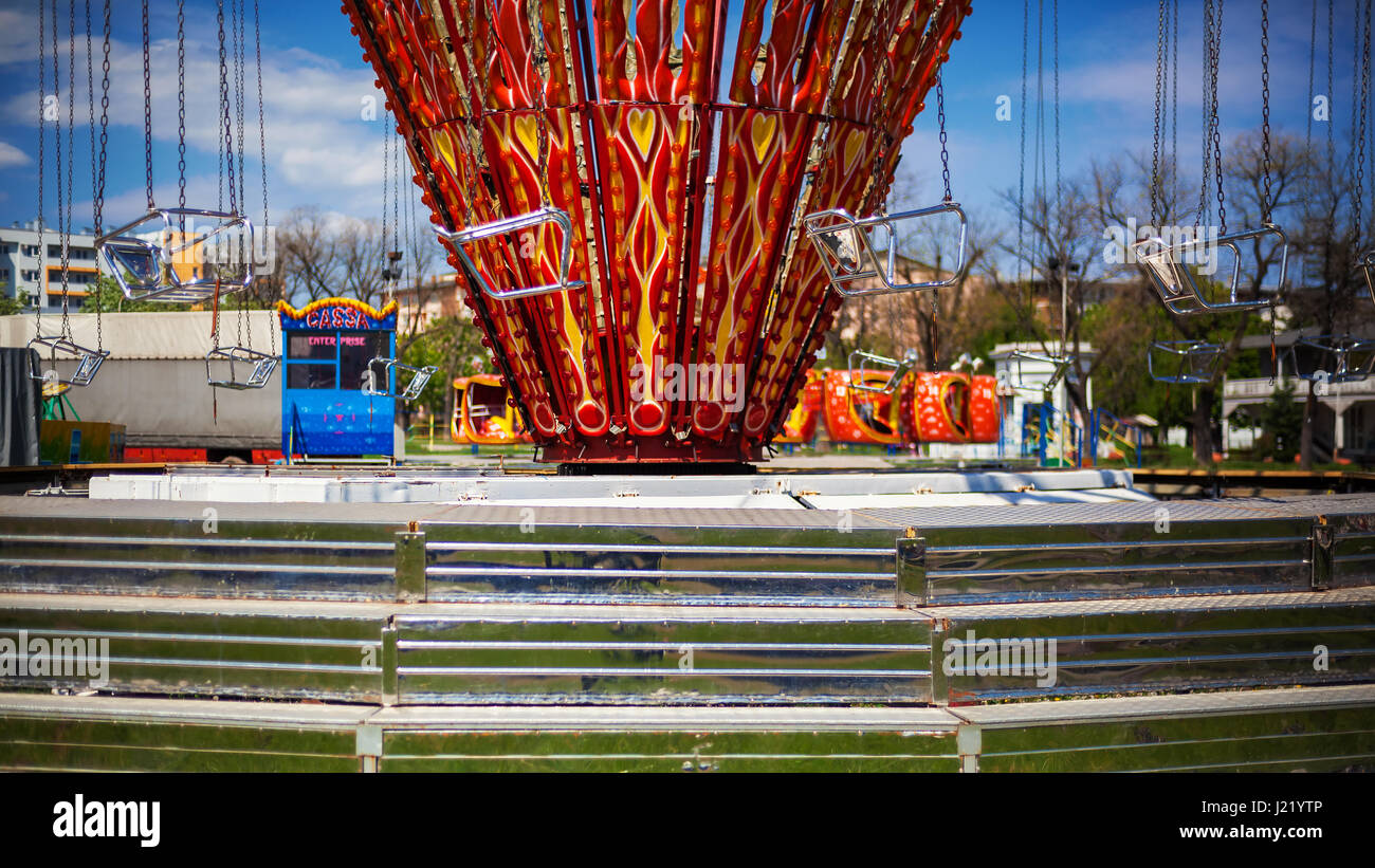 View on carousel seats, during spring sunny day Stock Photo - Alamy