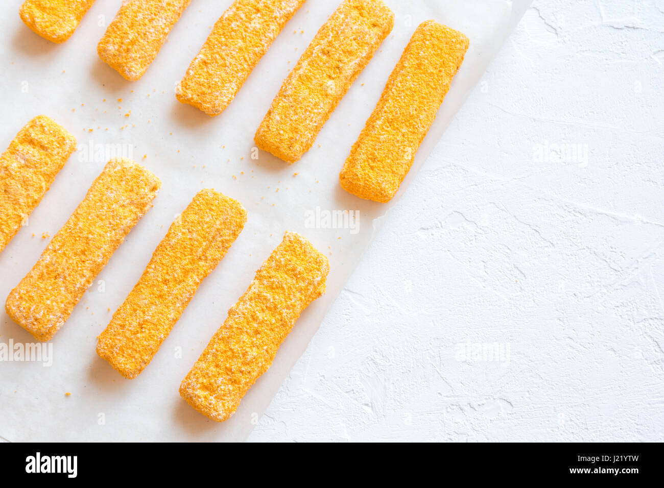 Frozen fish sticks, fish fingers on paper and white background, copy ...