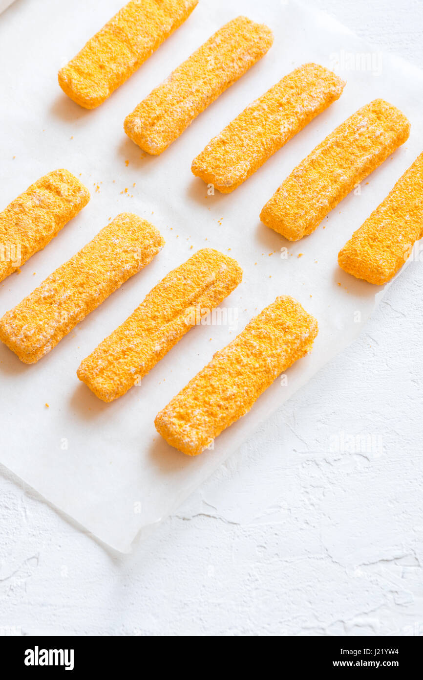 Frozen fish sticks, fish fingers on paper and white background, copy ...