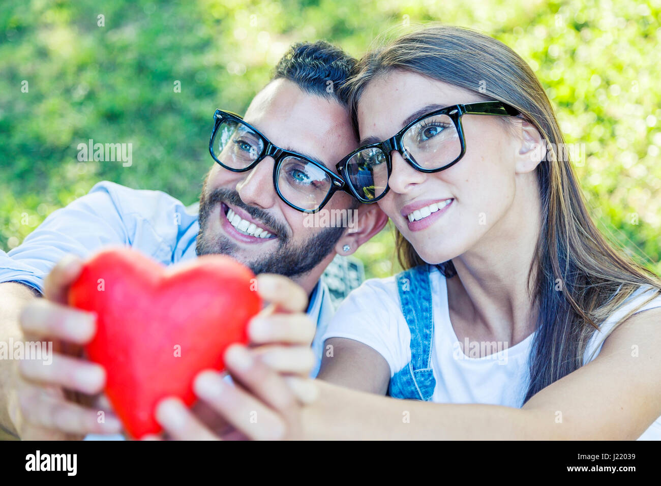 young couple showing a heart as a symbol of love Stock Photo - Alamy
