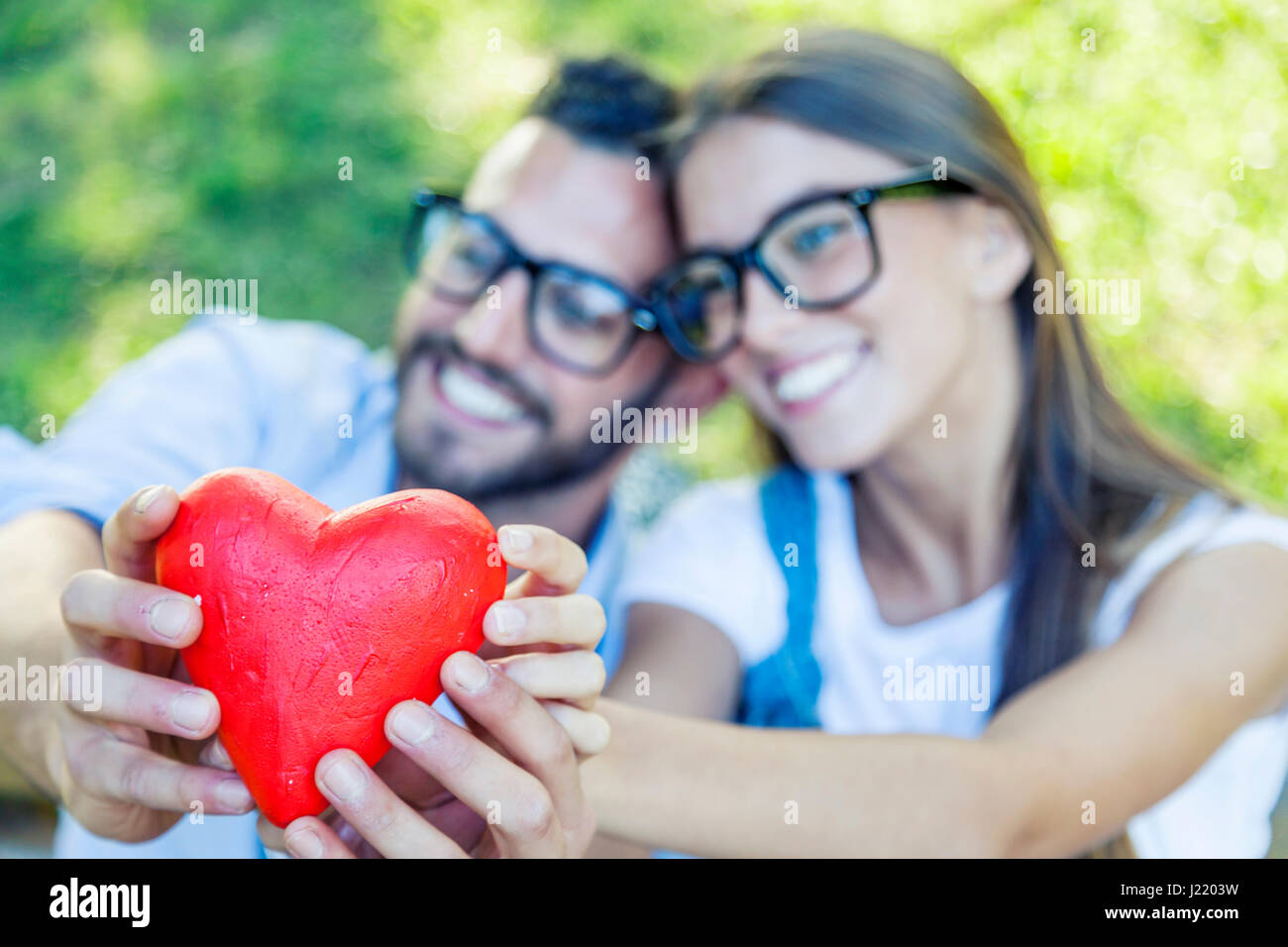 young couple showing a heart as a symbol of love Stock Photo - Alamy