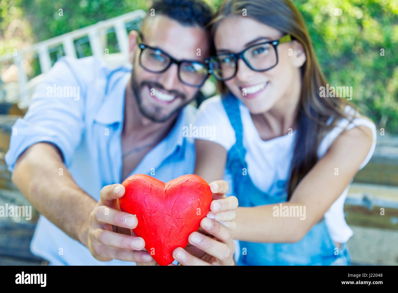 young couple showing a heart as a symbol of love Stock Photo - Alamy