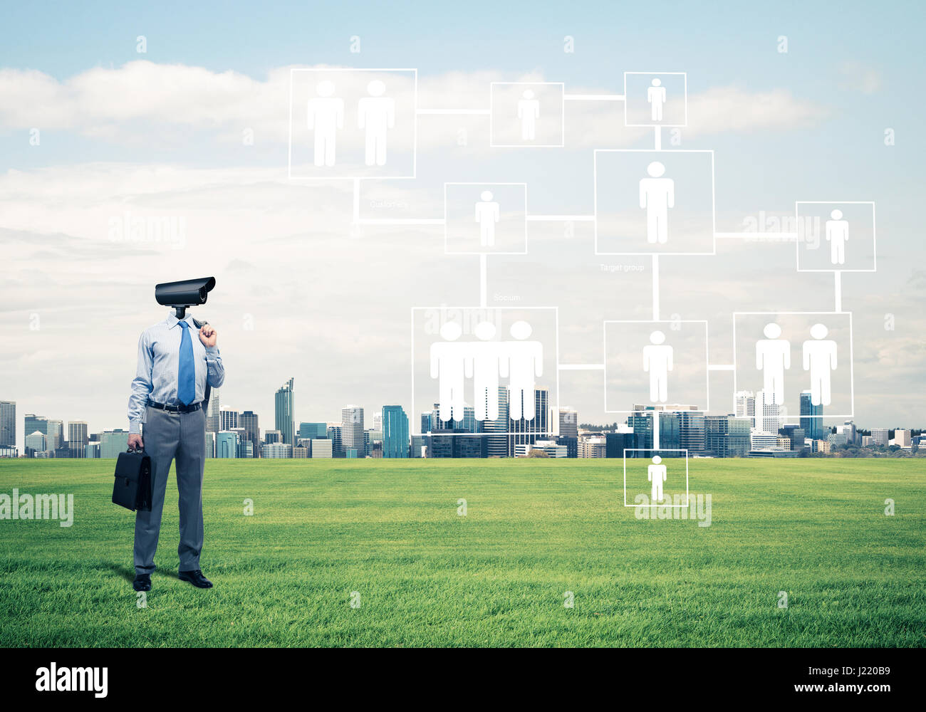 Camera headed man standing on green grass against modern citysca Stock ...
