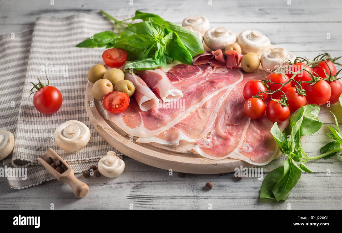 Healthy Mediterranean breakfast groceries: ham, vine tomatoes ...
