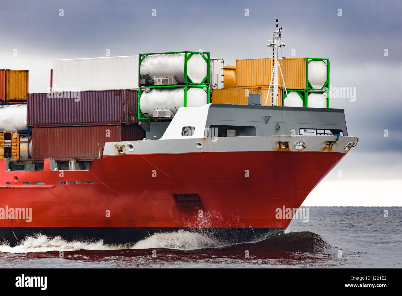 Red cargo container ship's bow in cloudy day Stock Photo - Alamy
