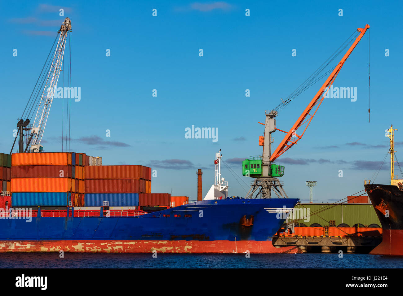 Blue container ship loading in cargo port of Europe Stock Photo - Alamy