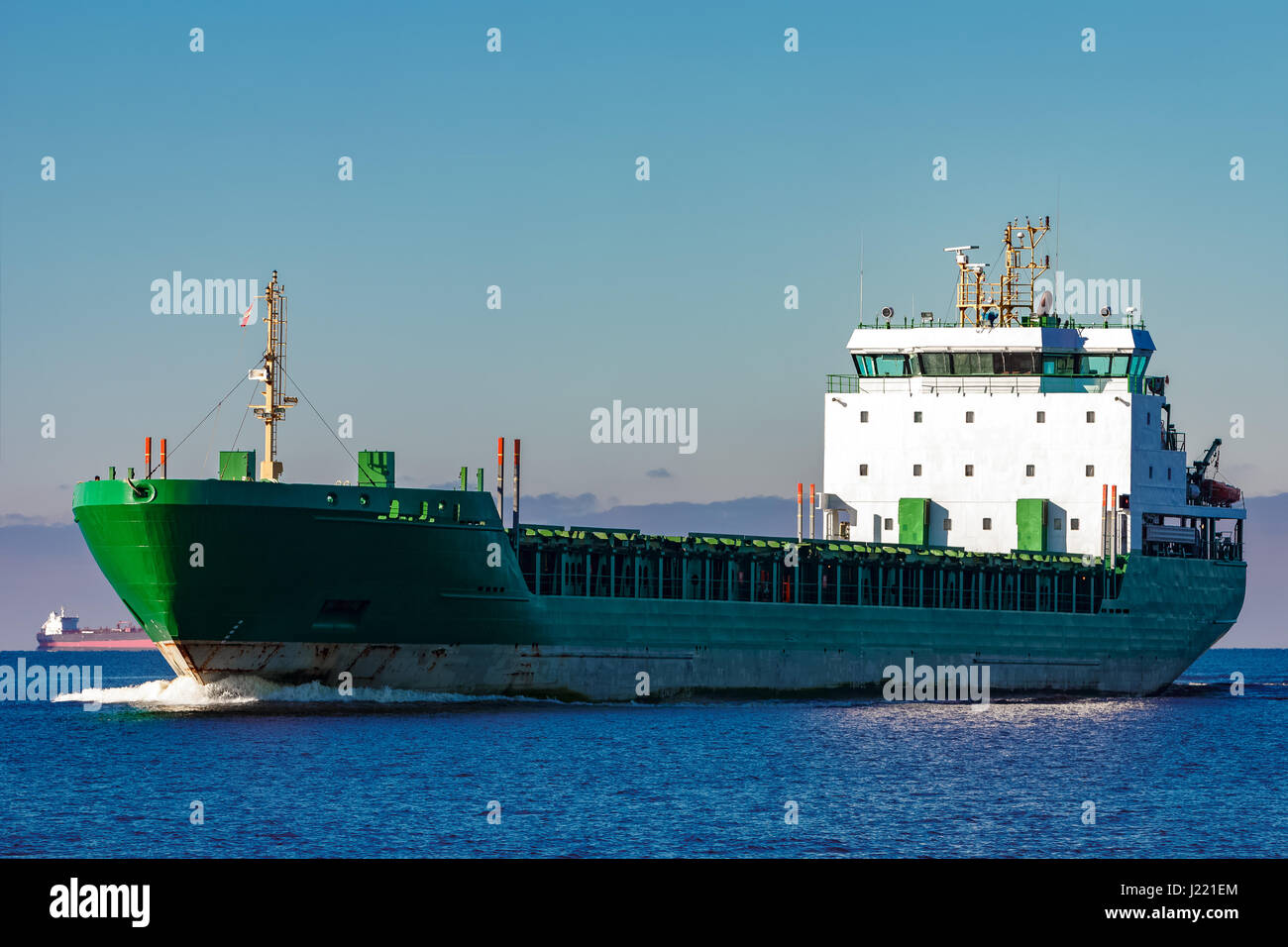 Green cargo ship moving in still water of Baltic sea Stock Photo - Alamy