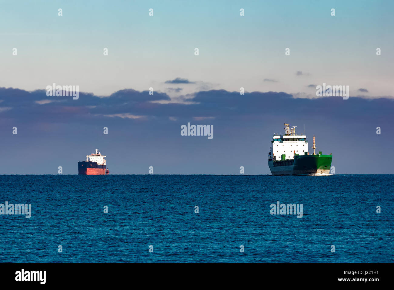 Cargo ships far in still water of Baltic sea Stock Photo - Alamy