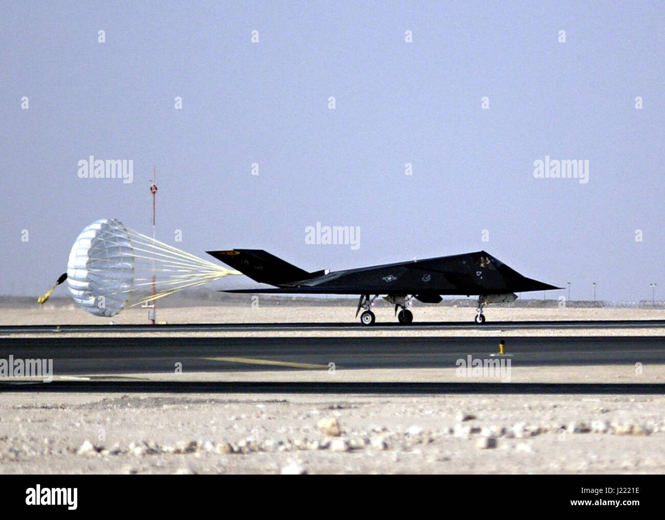 A US Air Force F-117 stealth fighter aircraft deploys a breaking Stock ...