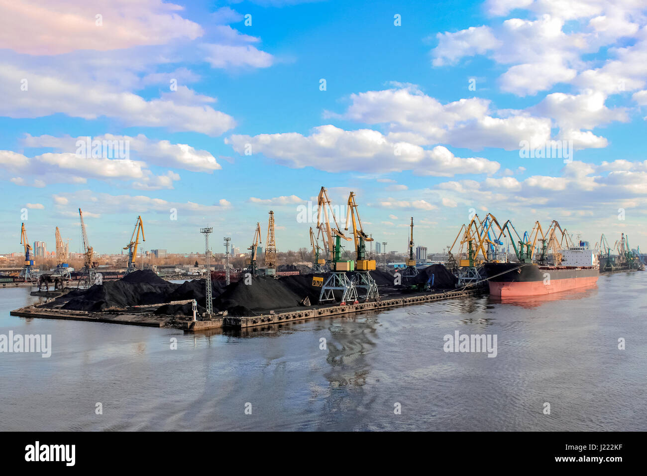 Baltic coal terminal with port cranes near the river. Riga cargo Stock ...