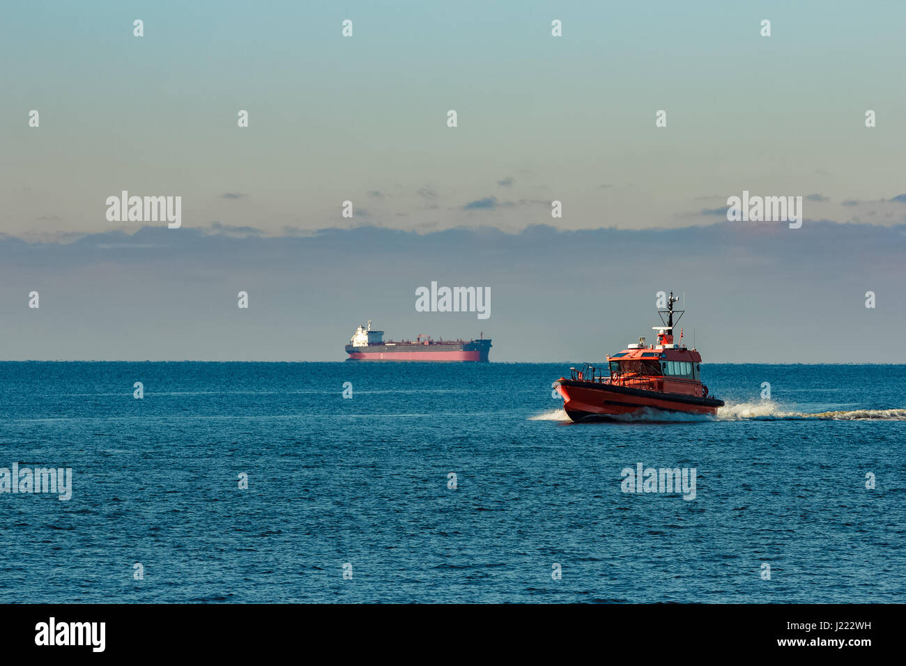 Orange pilot ship moving fast from Baltic sea Stock Photo - Alamy