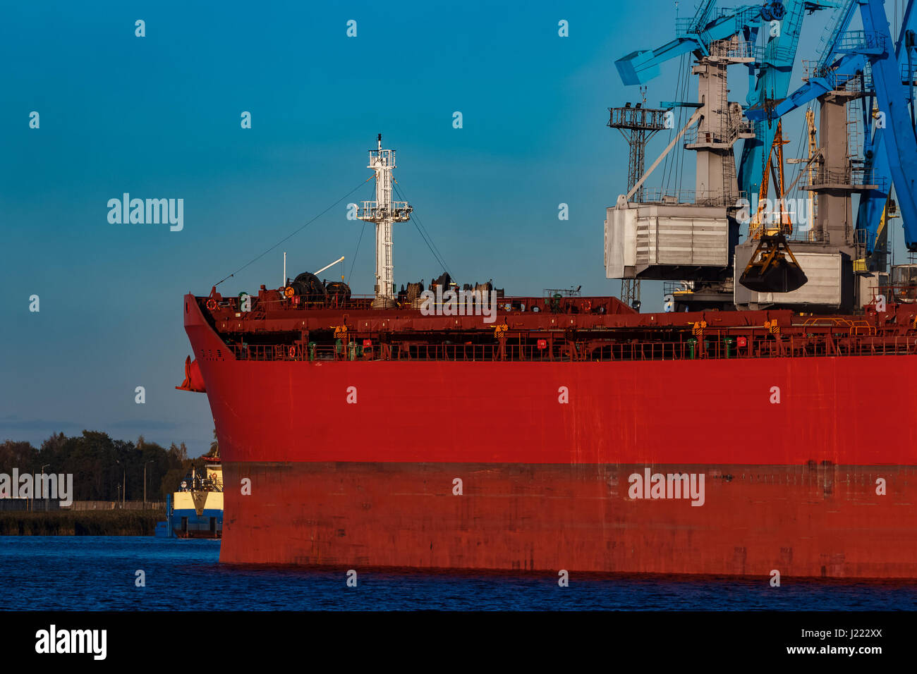 Red cargo ship loading in the port of Riga, Europe Stock Photo - Alamy