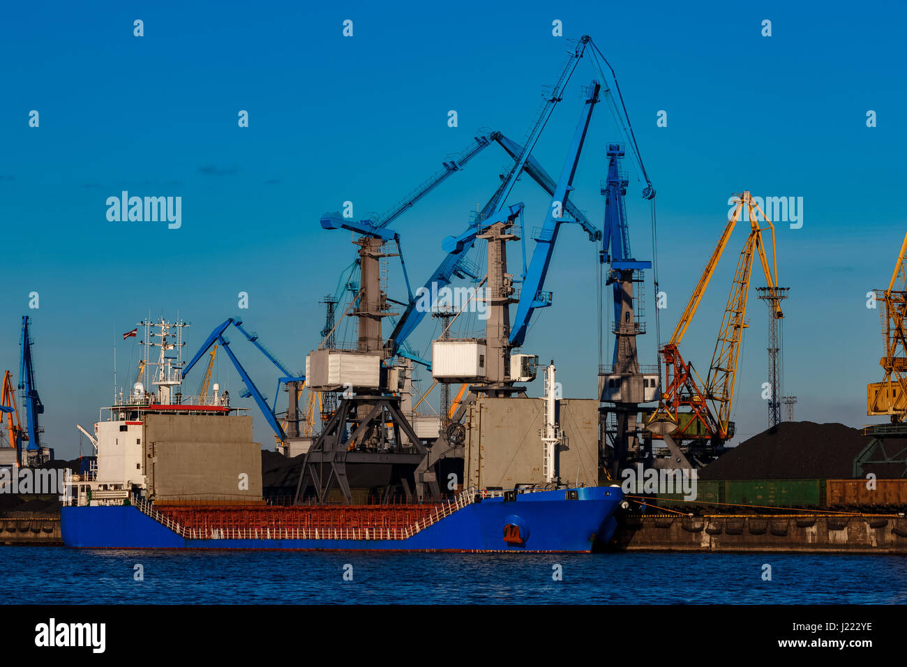 Blue cargo ship loading in the port of Riga, Europe Stock Photo - Alamy