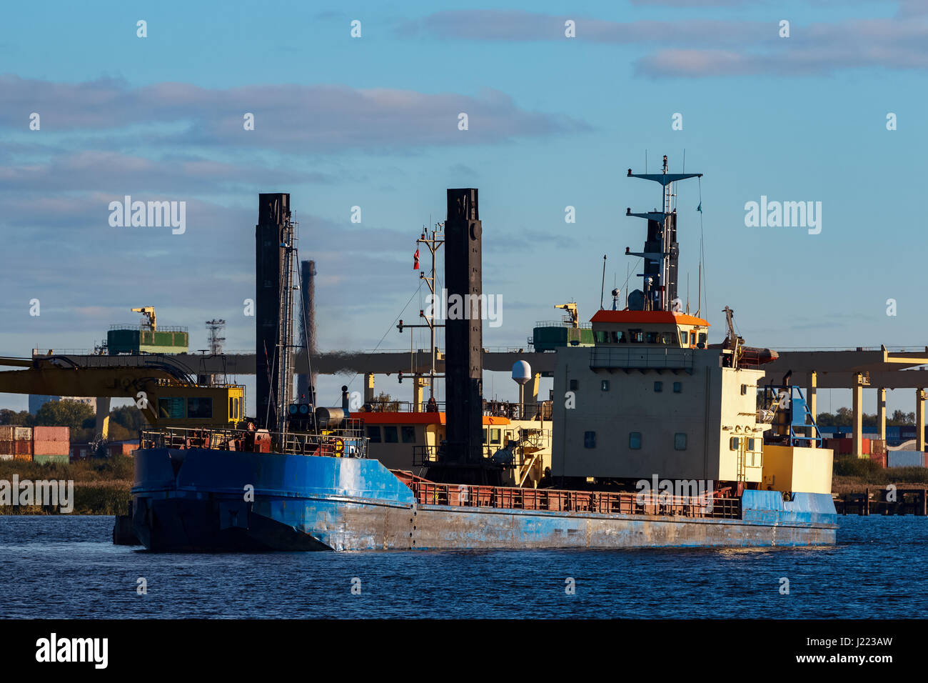 Blue cargo ship in the port of Riga, Europe Stock Photo - Alamy