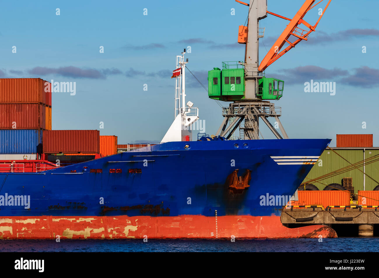 Blue container ship loading in cargo port of Europe Stock Photo - Alamy