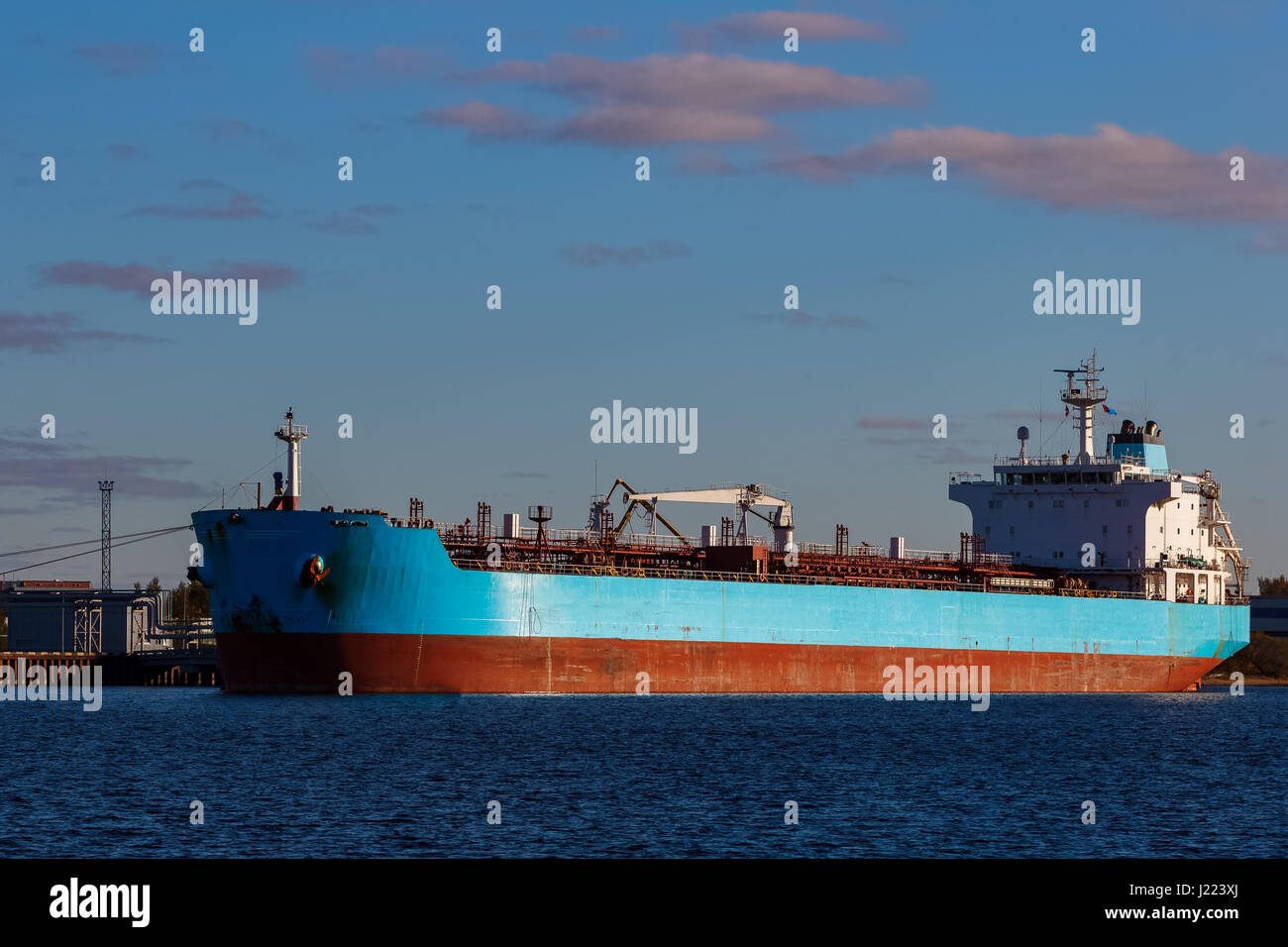 Blue cargo ship loading in the port of Riga, Europe Stock Photo - Alamy