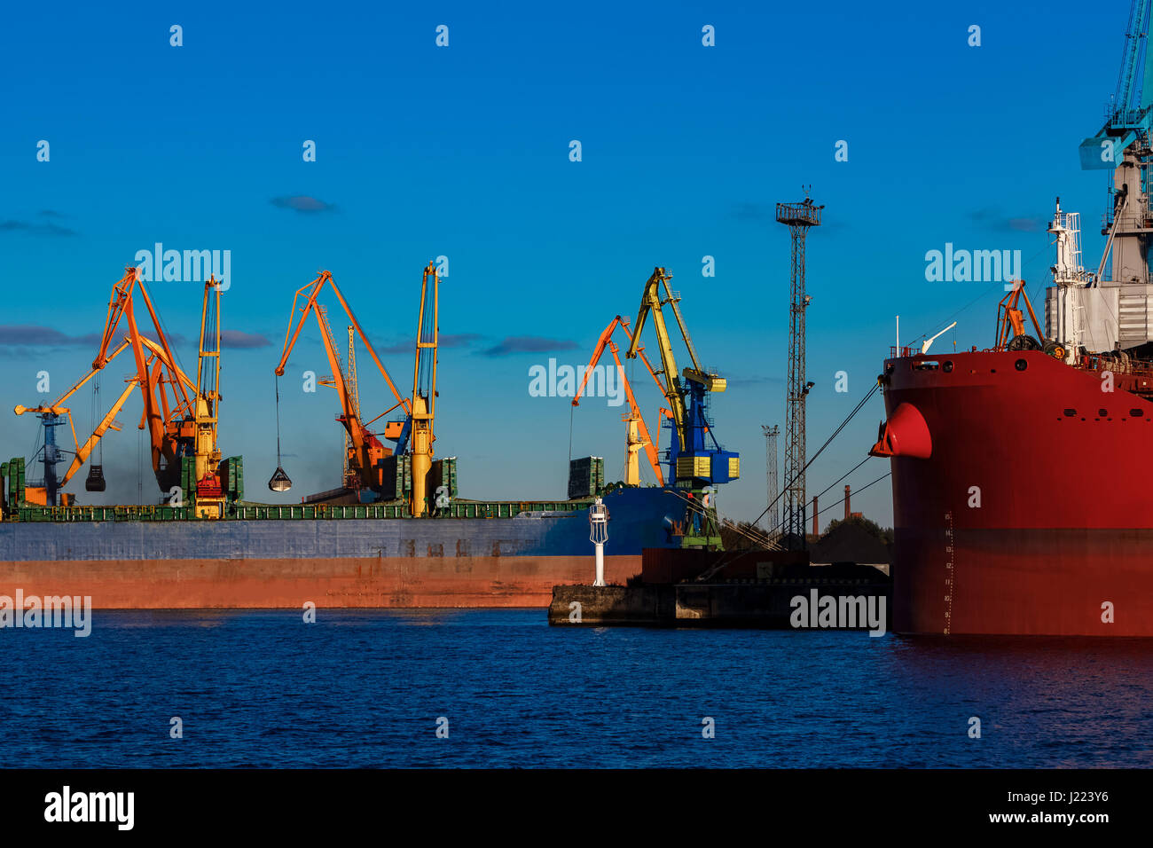 Blue cargo ship loading in the port of Riga, Europe Stock Photo - Alamy