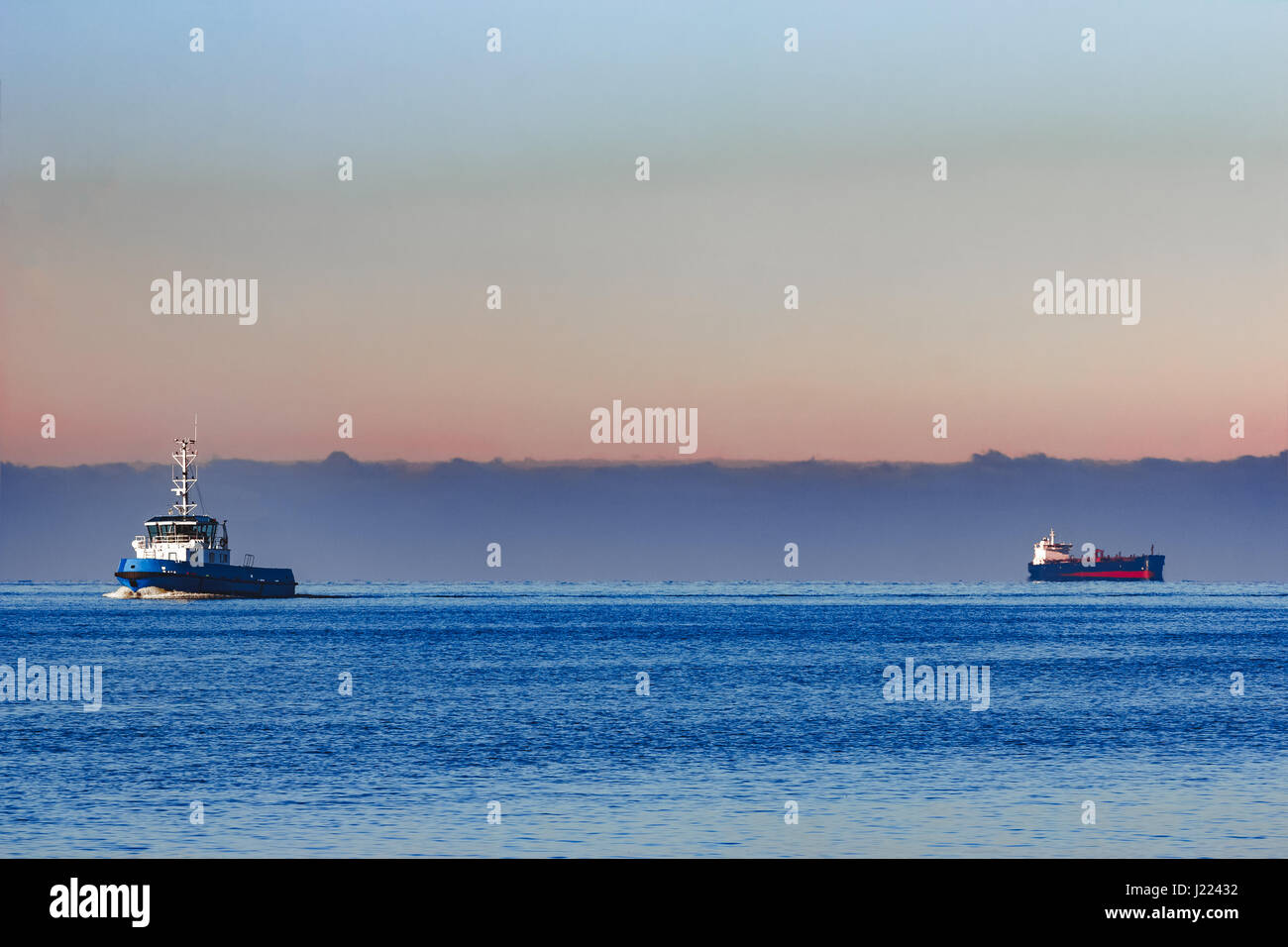 Blue small tug ship sailing from the Baltic sea in the morning Stock ...