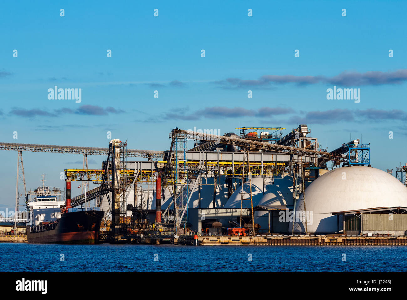 Black cargo ship loading in the port of Riga, Europe Stock Photo - Alamy