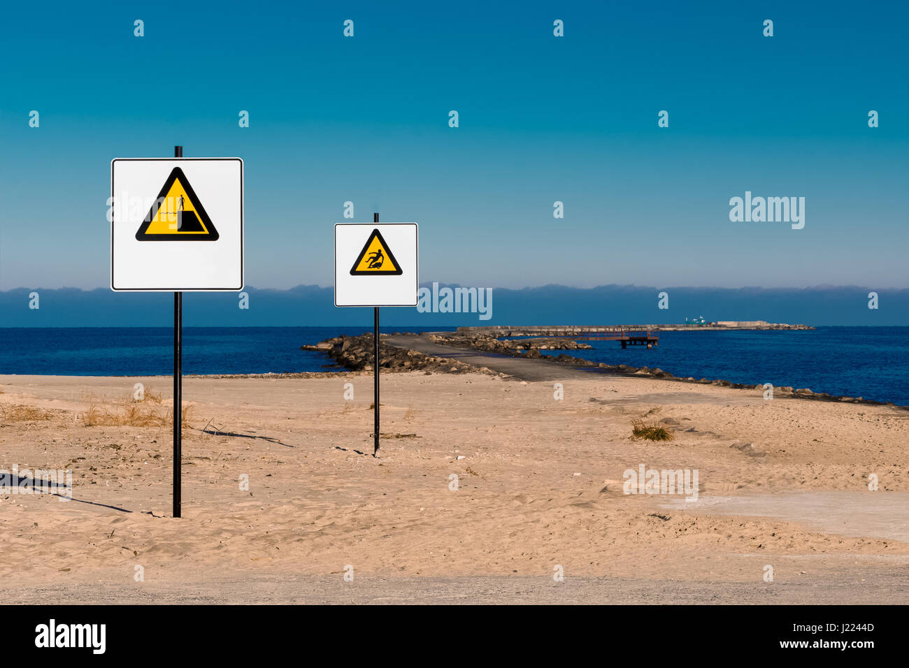 Yellow warning signs on summer beach, Riga Stock Photo - Alamy