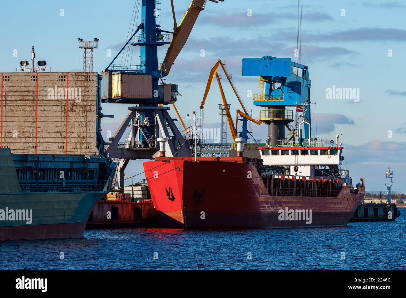 Red cargo ship loading in the port of Riga, Europe Stock Photo - Alamy