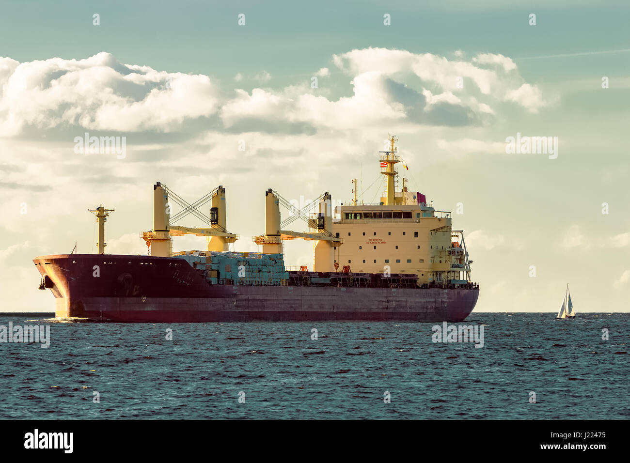 Red cargo ship moving entering the port of Riga Stock Photo - Alamy