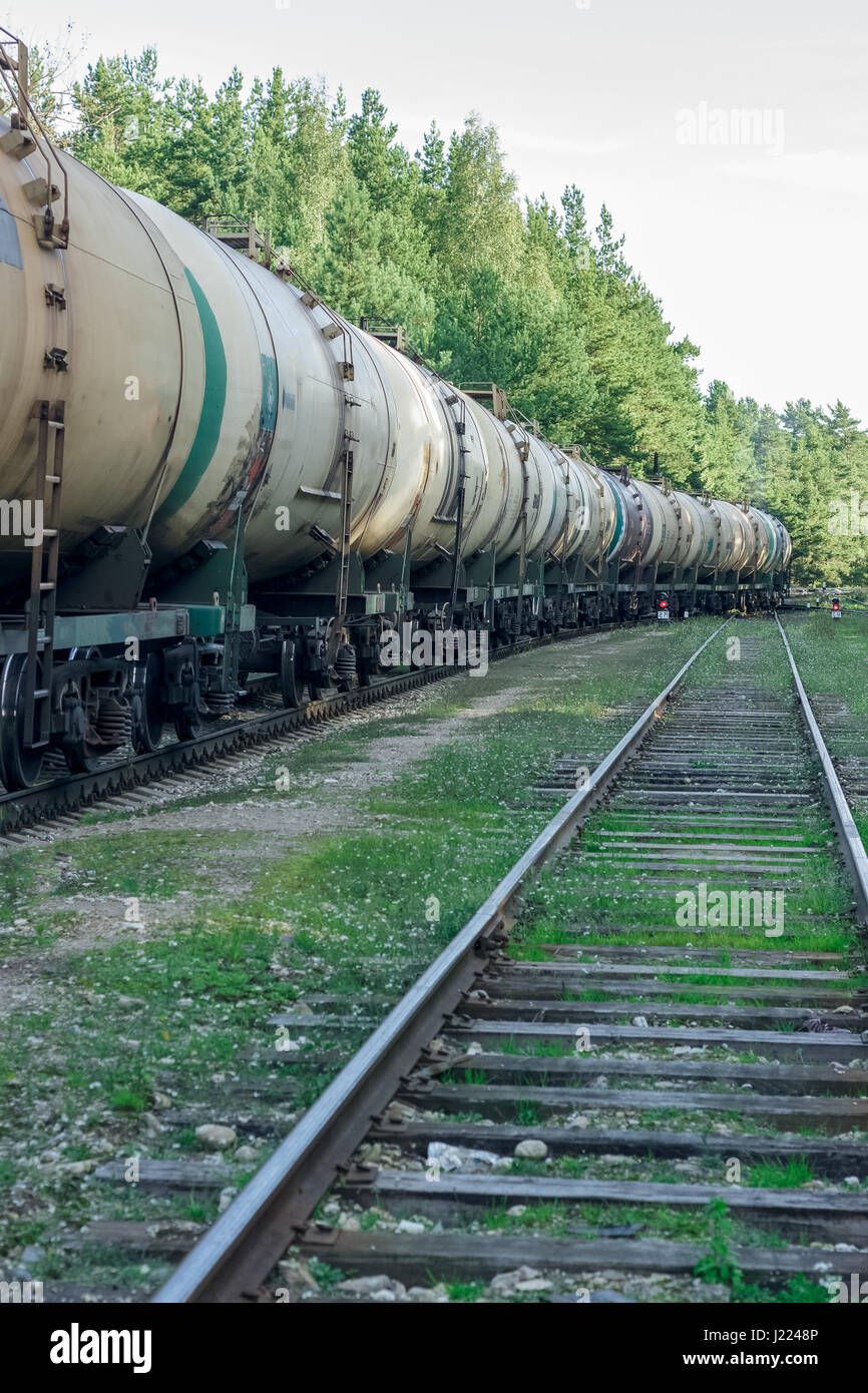 Tank wagons with oil. Freight train in forest Stock Photo - Alamy